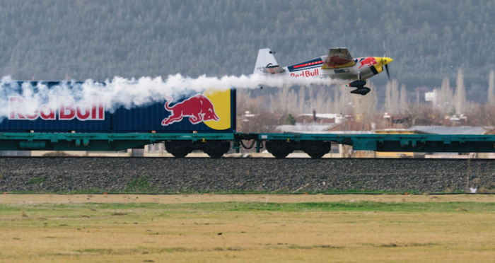 Red Bull pilot Dario Costa lands plane on moving cargo train in world ...